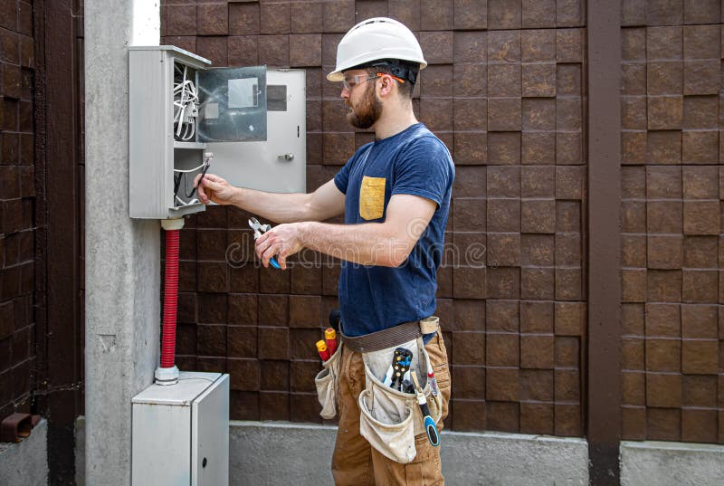 Electrician Builder at Work, Examines the Cable Connection in the ...