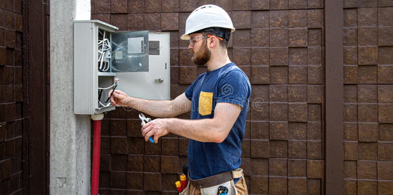 Electrician Builder at Work, Examines the Cable Connection in the ...