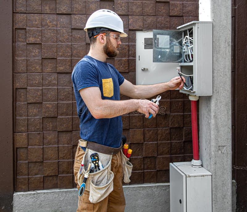 Electrician Builder at Work, Examines the Cable Connection in the ...