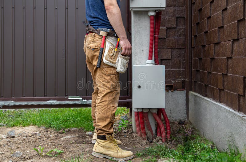 Electrician Builder at Work, Examines the Cable Connection in the ...