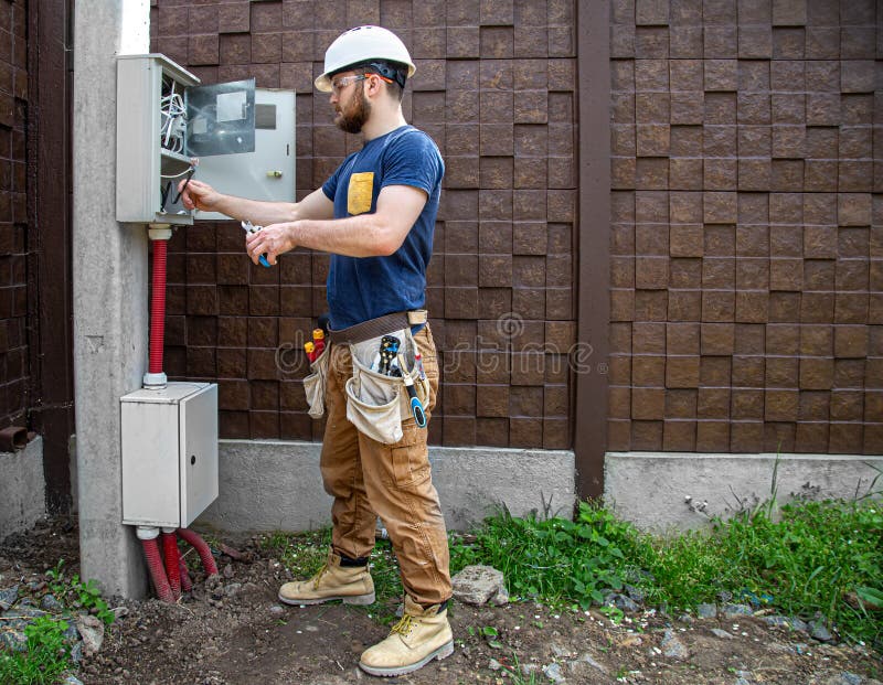 Electrician Builder at Work, Examines the Cable Connection in the ...