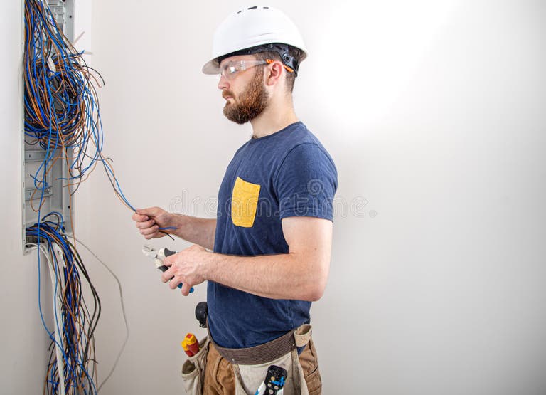 Electrician Builder at Work, Examines the Cable Connection in the ...