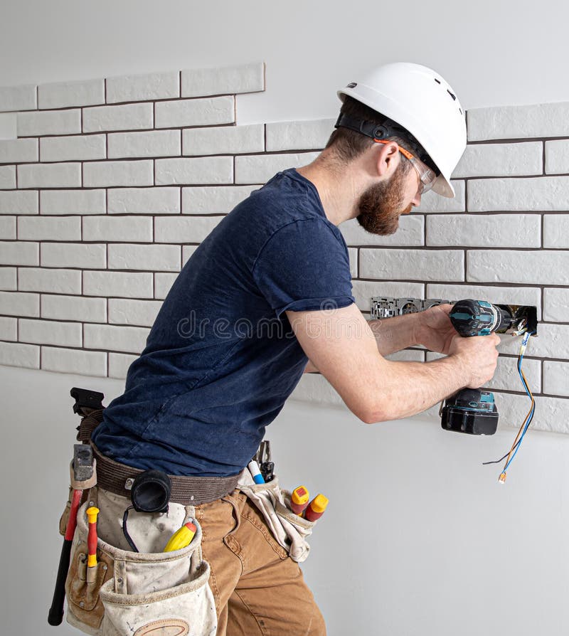 Electrician Builder at Work, Installation of Lamps at Height ...