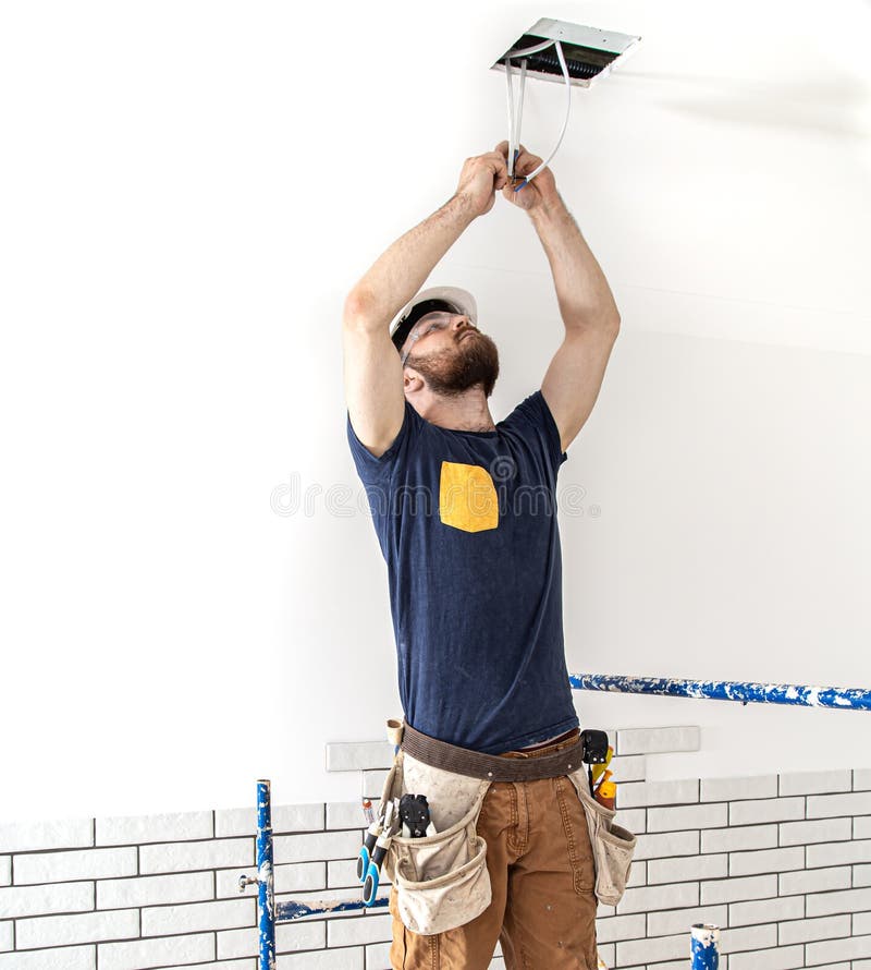 Electrician Builder at Work, Installation of Lamps at Height ...