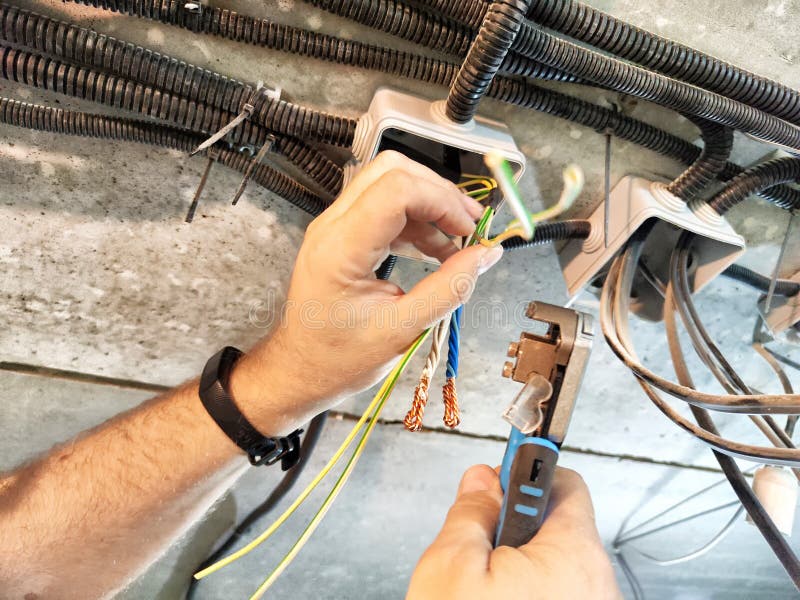Technician Working on Electrical Connections in a Structured Wiring ...