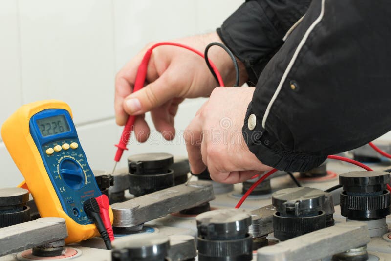 Electrician Check Battery with Yellow Multimeter Stock Image - Image of ...