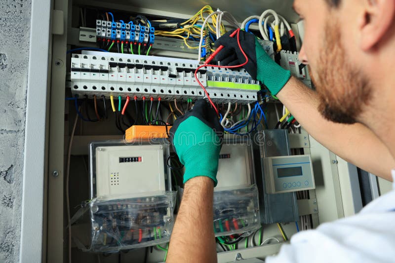 Electrician Checking Electric Current with Multimeter Indoors, Closeup ...