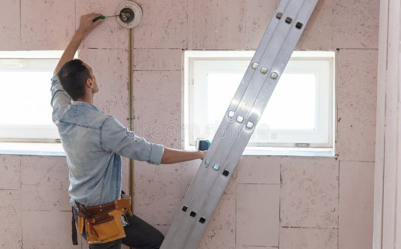 Electrician Checking Lighting To the Ceiling in the Home, Technician ...
