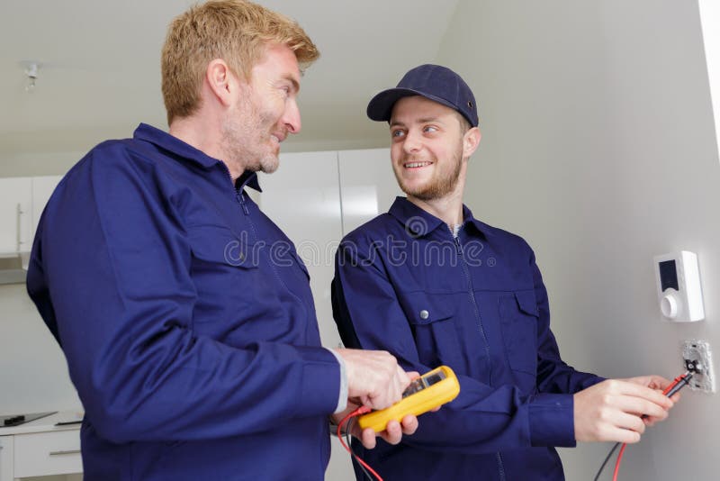 Electrician Checking Voltage in Electrical Wall Socket Stock Photo ...
