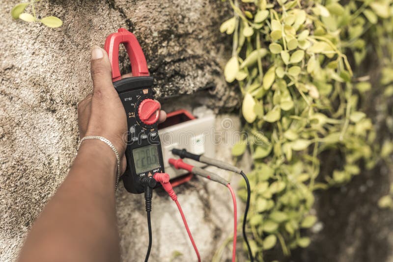 An Electrician Checking the Voltage of a Installed Outdoor Combo Outlet ...