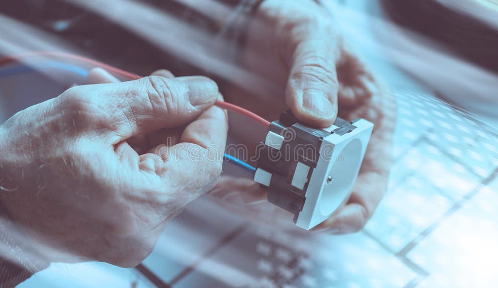 Electrician Connecting a Wire into a Power Socket, Light Effect Stock ...