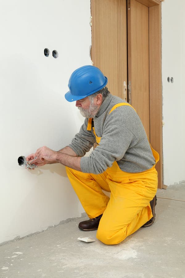 Electrician at Construction Site Install Electrical Plug Stock Photo ...