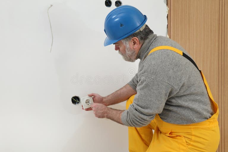 Electrician at Construction Site Install Electrical Plug Stock Photo ...