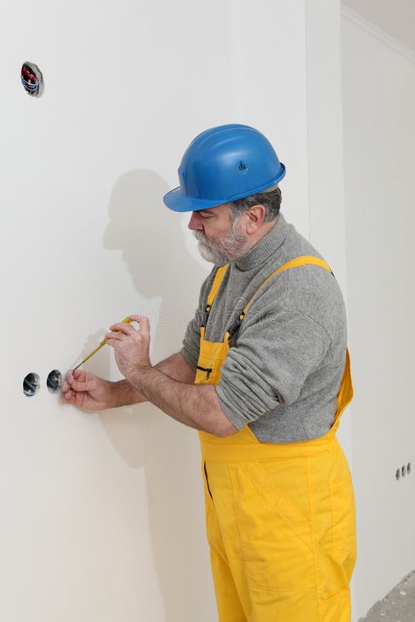 Electrician at Construction Site Install Electrical Plug Stock Photo ...
