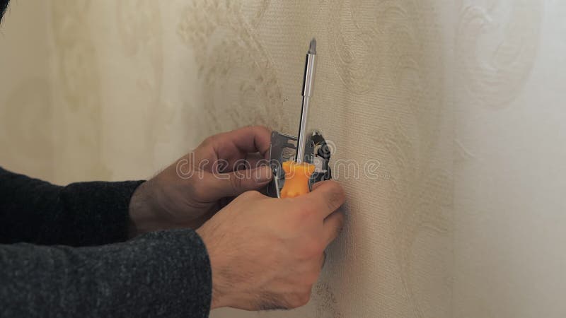 The Electrician Disassembles the Socket on the Wall. the Concept of a ...