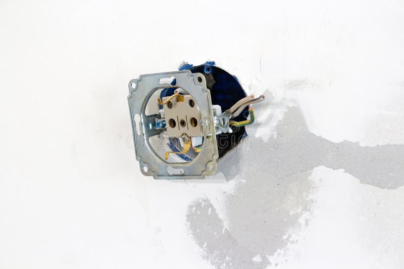 Electrician Dismantling Broken Electric Wall Socket. on Grey Brick and ...
