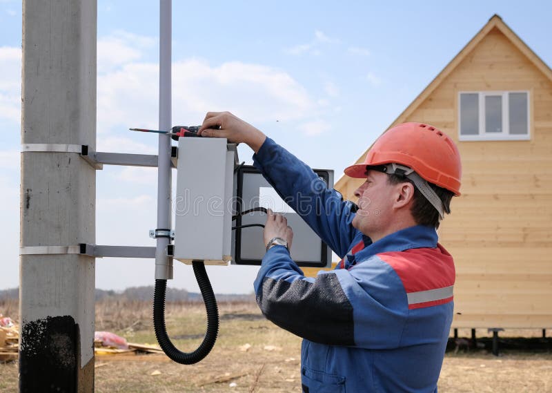 Electrician Engaged in the Installation of Electricity Meter on the ...