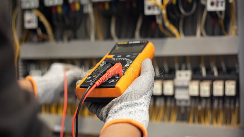 Electrician Engineer Uses a Multimeter To Test the Electrical ...