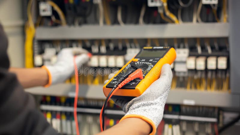 Electrician Engineer Uses a Multimeter To Test the Electrical ...