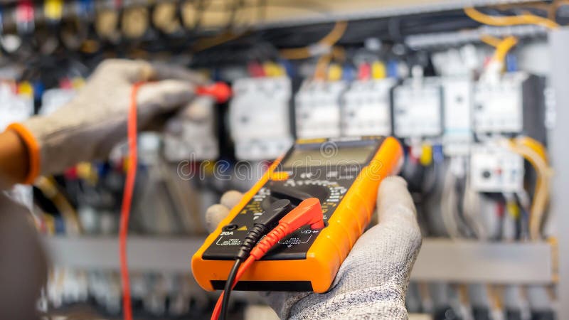 Electrician Engineer Uses a Multimeter To Test the Electrical ...