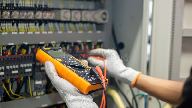 Electrician Engineer Uses a Multimeter To Test the Electrical ...