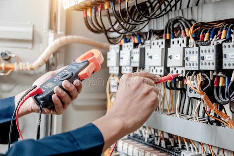 Electrician Engineer Uses A Multimeter To Test The Electrical ...