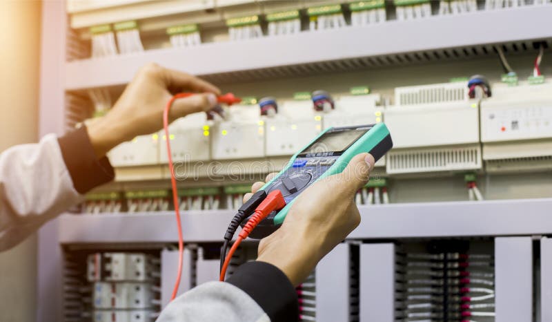 Electrical Engineer Tests the Operation of the Electric Control Cabinet ...