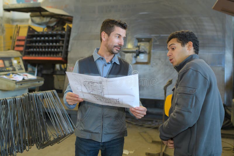 Electrician Explaining Trainee Building Electric Plan Stock Photo ...