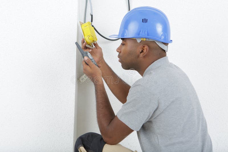 Electrician fixing cable stock photo. Image of helmet - 314279116