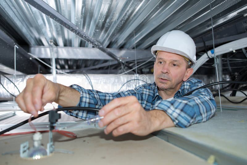 Electrician Fixing Cable To Spotlight Stock Photo - Image of industrial ...