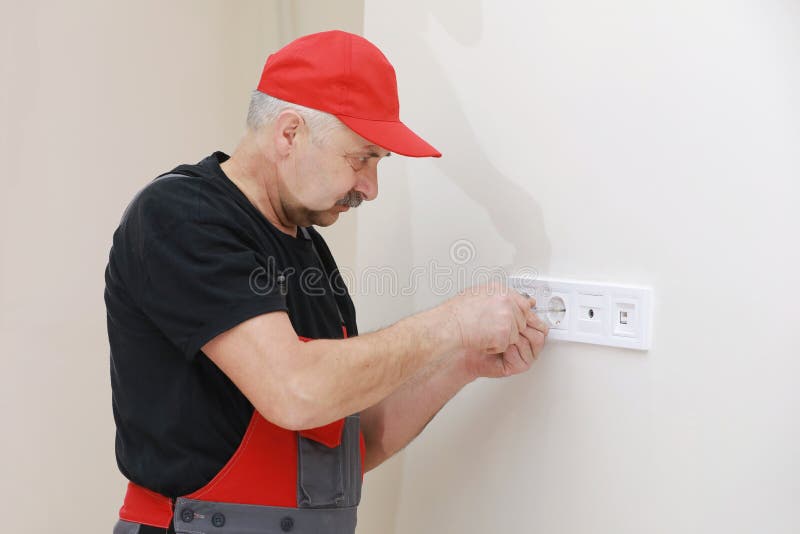 Electrician Hands Tighten Electrical Wires in Wall Fixture or Socket ...