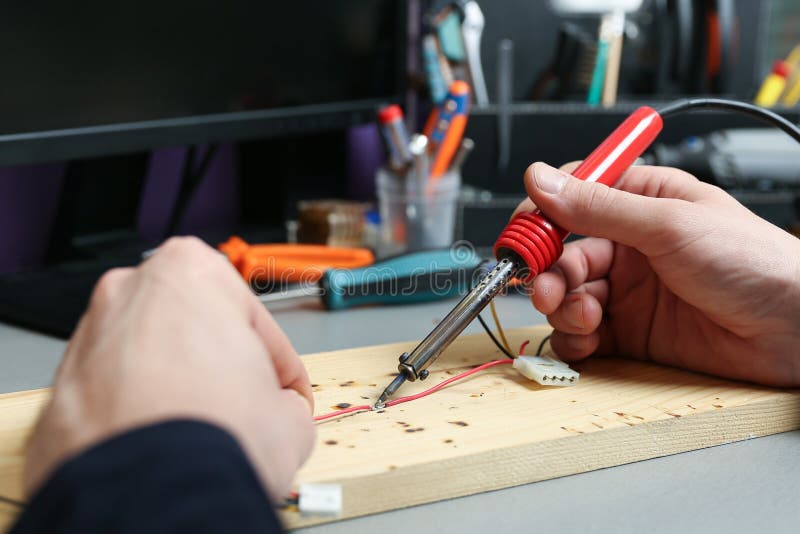 Electrician Hands are Working with Soldering Iron in Workshop Stock ...