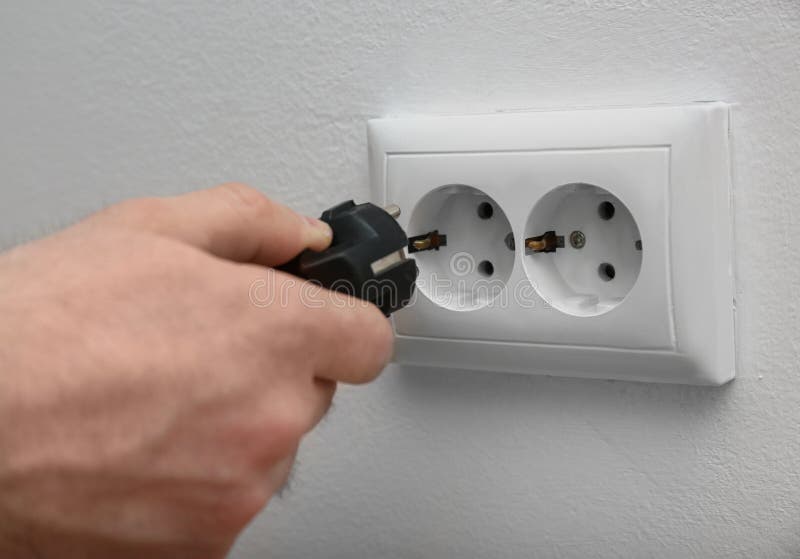 Electrician Inserting Plug into Power Socket on White, Closeup Stock ...