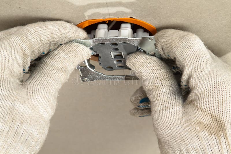 Electrician Inserts an Electrical Outlet into the Socket Box Stock ...