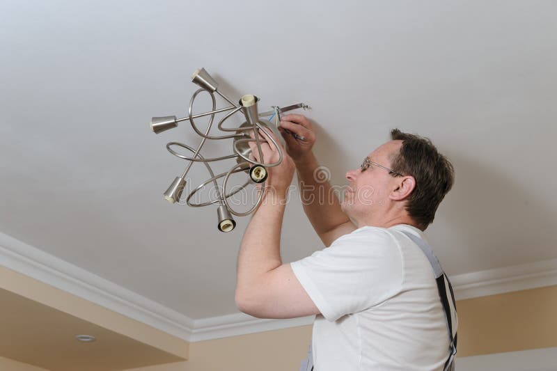 Electrician is Installing and Connecting a Lamp. Stock Photo - Image of ...