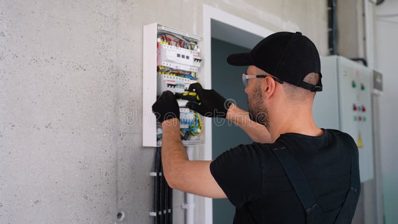 Electrician Installing Electrical Panel in Office or House Stock ...