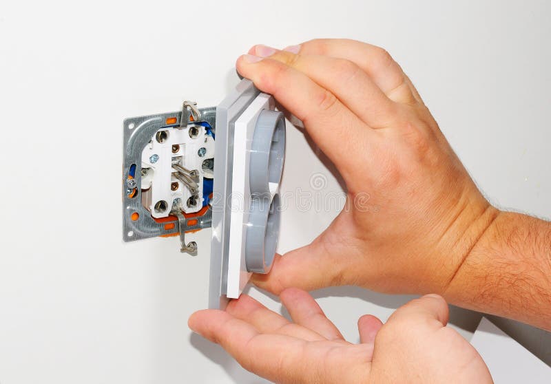 Electrician Installing a Grey Wall-mounted AC Power Socket with a ...