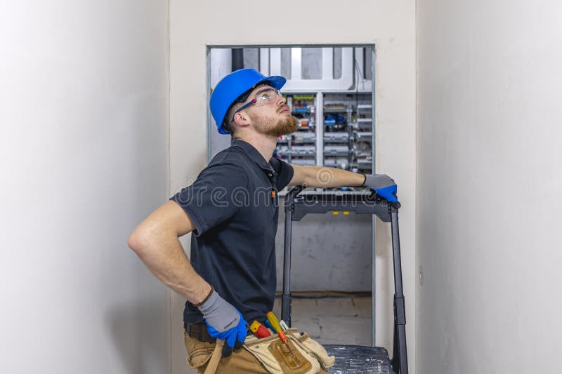 Electrician Installing Laying Electrical Cables on the Ceiling Inside ...