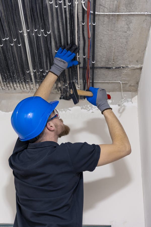 Electrician Installing Laying Electrical Cables on the Ceiling Inside ...