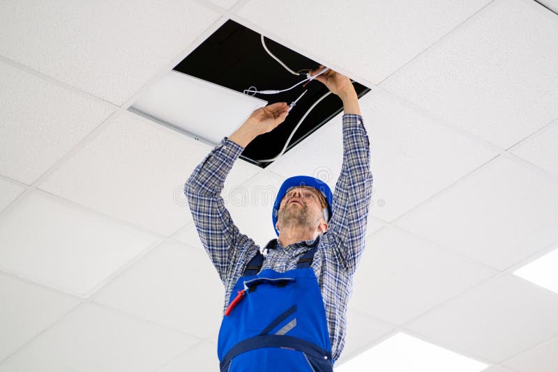 Electrician Installing LED Ceiling Light Stock Image - Image of ...
