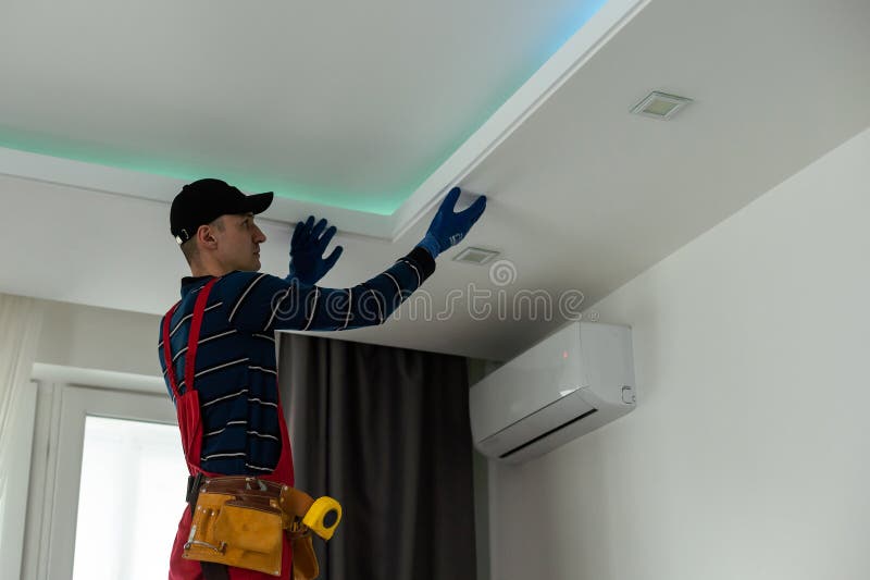An Electrician is Installing LED Spotlights on the Ceiling. Stock Image ...
