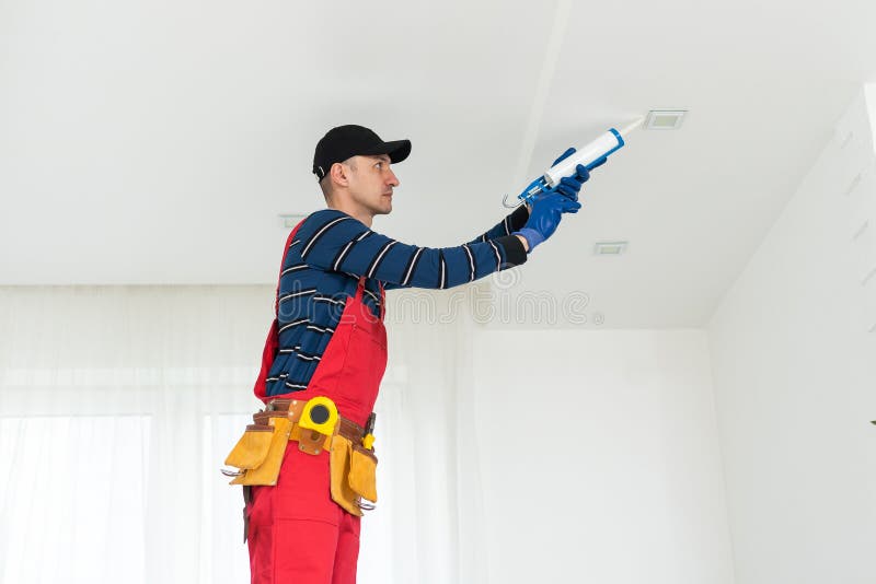 An Electrician is Installing LED Spotlights on the Ceiling. Stock Photo ...