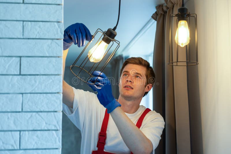 An Electrician is Installing LED Spotlights on the Ceiling. Stock Photo ...