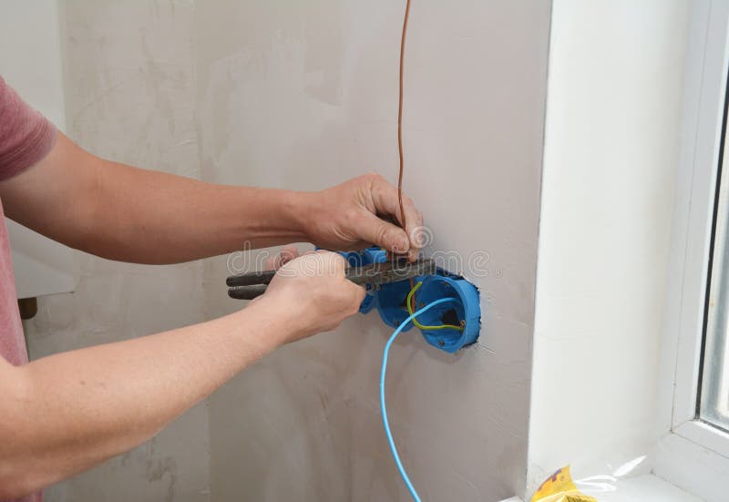 An Electrician is Installing, Adding New Electrical Socket, Connecting ...
