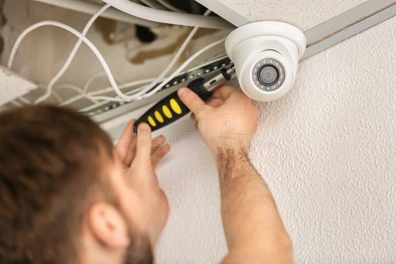 Electrician Installing Security Camera Indoors Stock Photo - Image of ...