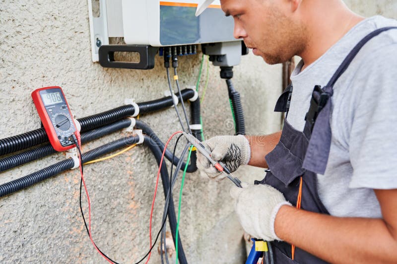 Electrician Installing Solar Panel System, Wiring Inverter and Electric ...