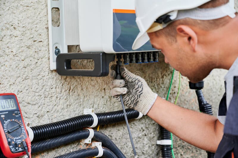 Electrician Installing Solar Panel System, Wiring Inverter and Electric ...