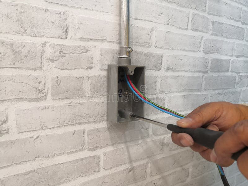 Electrician Installing Wall Socket For Electrical System Work On Gray ...