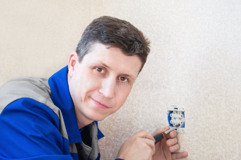 The Electrician Installs an Electrical Outlet Stock Photo - Image of ...