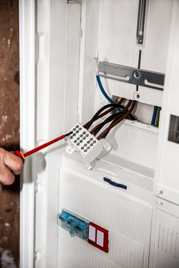 An Electrician Installs a New Switch Box or Fuse Box Stock Image ...